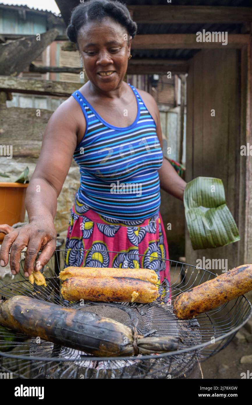 Woman cooking street food on a grill in the streets of Sao Joao dos ...