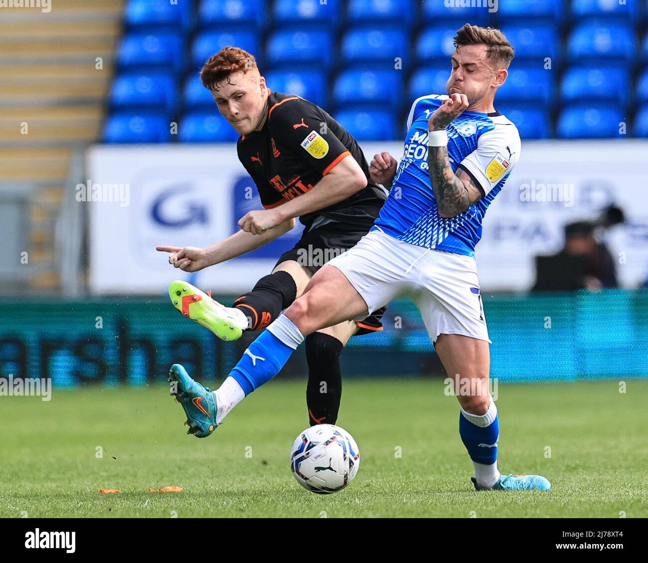 Sonny Carey #16 of Blackpool passes the ball through Harrison Burrows ...