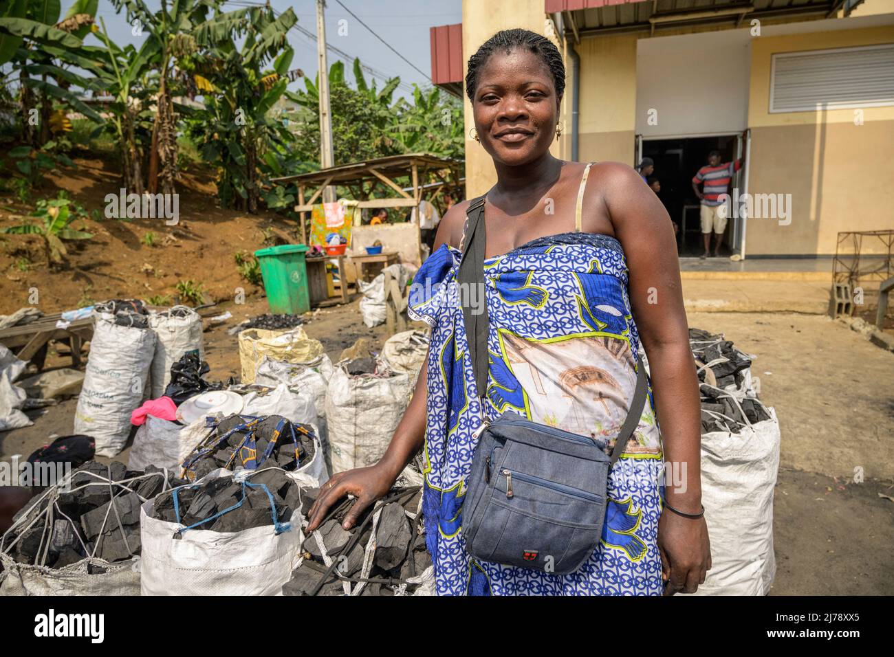Lady selling charcoal at a street stall next to the Bobo Forro market ...