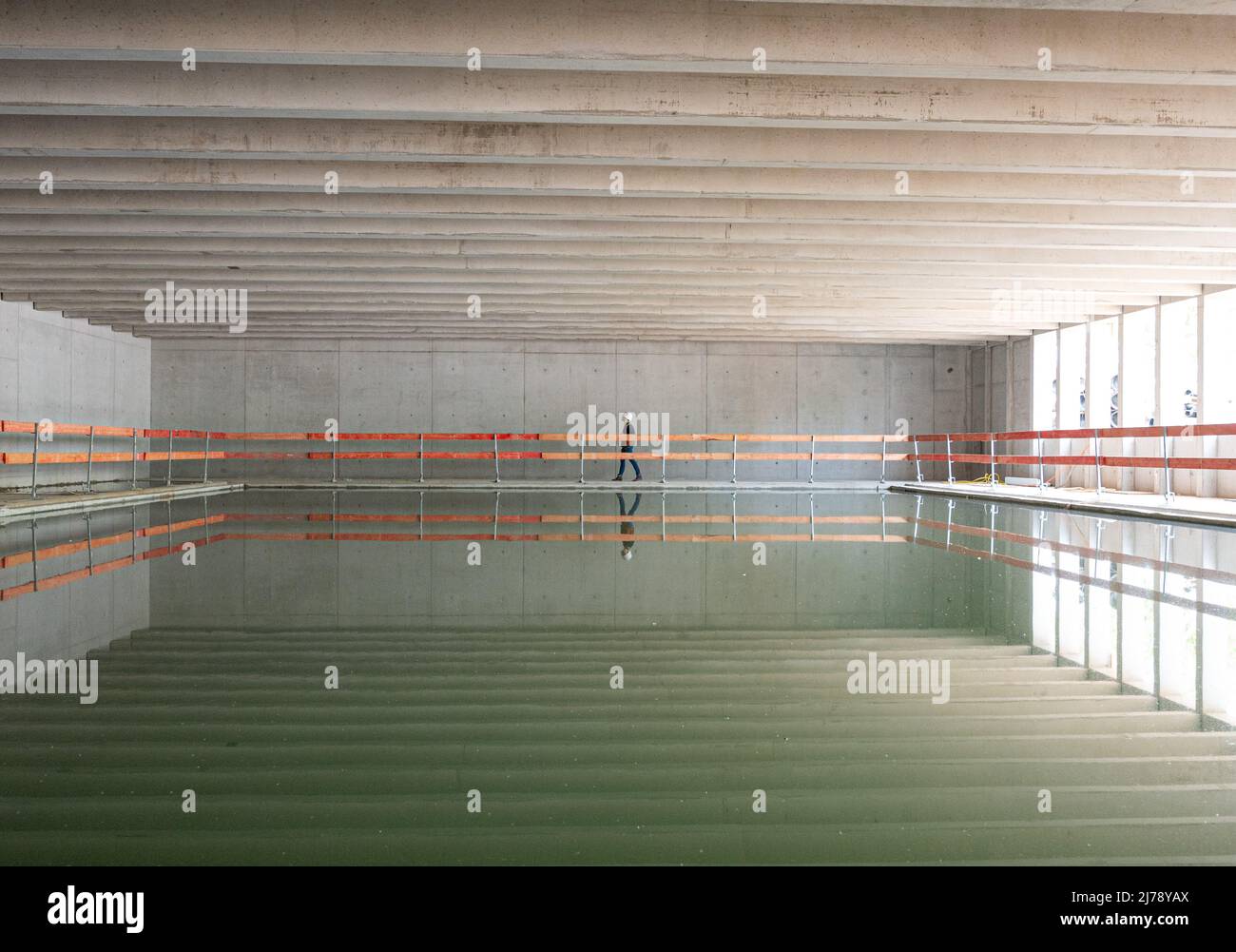 07 May 2022, Hamburg: A woman walks along a pool during a tour of the ...