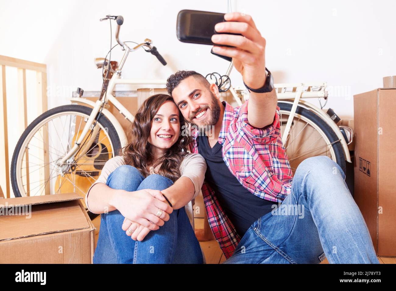 beautiful young couple take a selfie after moving Stock Photo - Alamy