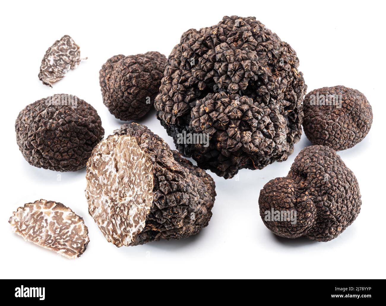 Black edible winter truffles on white background. The most famous of ...