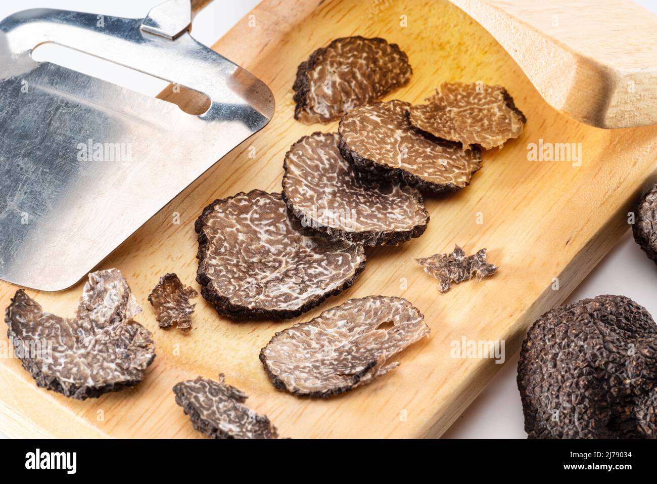 Black edible winter truffle on white background. The most famous of the ...