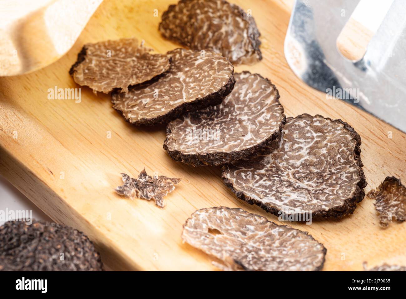 Black edible winter truffle on white background. The most famous of the ...
