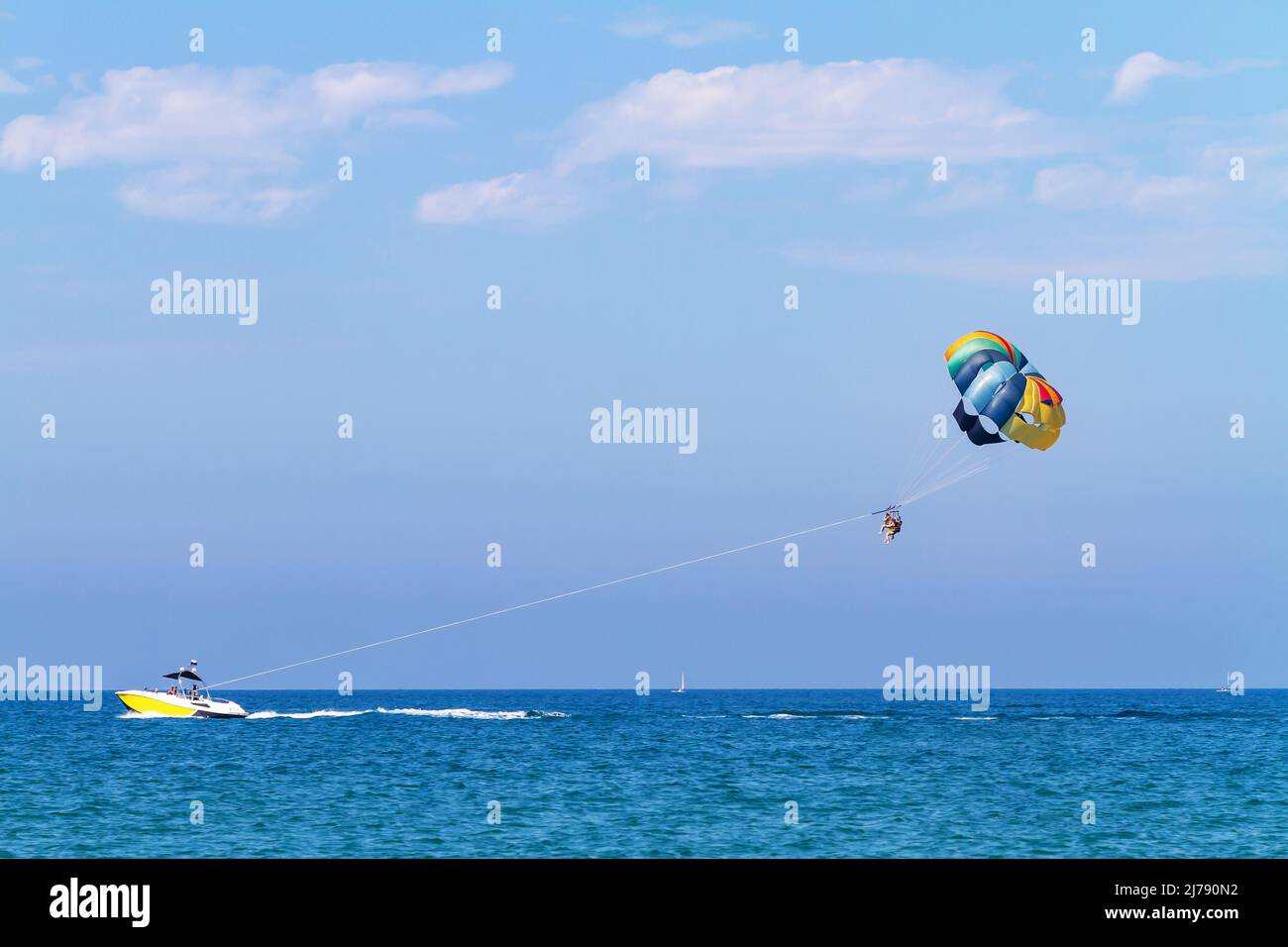 Parasailing water amusement - flying on a parachute behind a boat on a ...