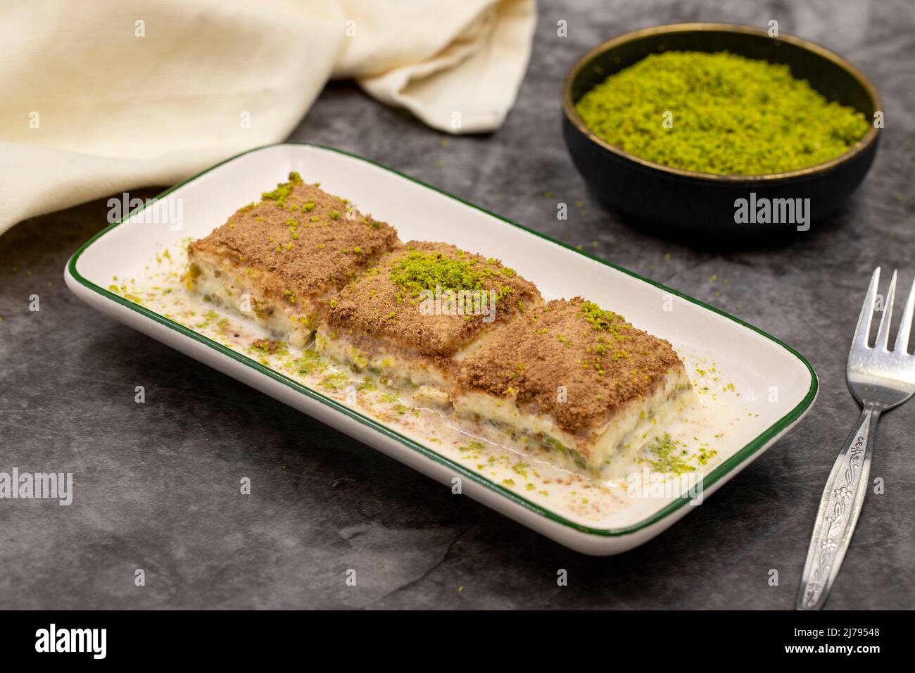 Cold baklava. Baklava with milk on a dark background. Mediterranean ...