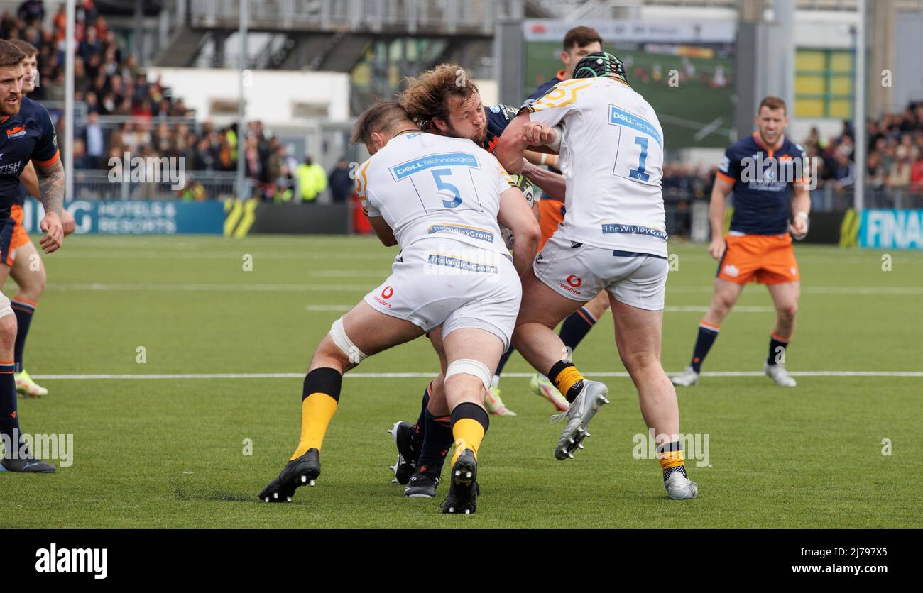 Edinburgh's Pierre Schoeman gets taken down by Wasps Elliot Stooke and ...