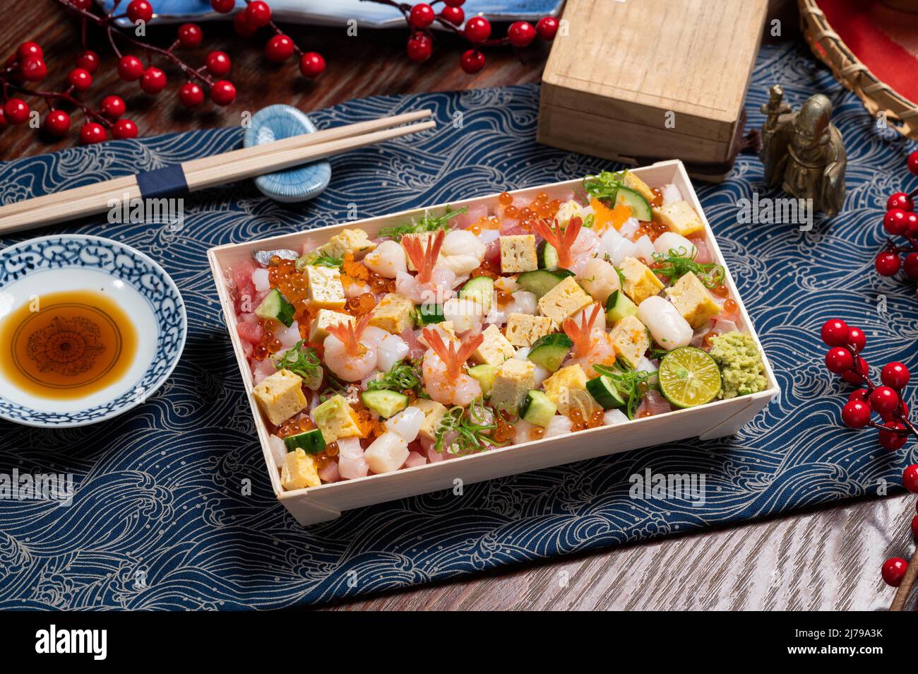 Arashi shrimp chirashi sushi in a dish with chopsticks isolated on mat ...