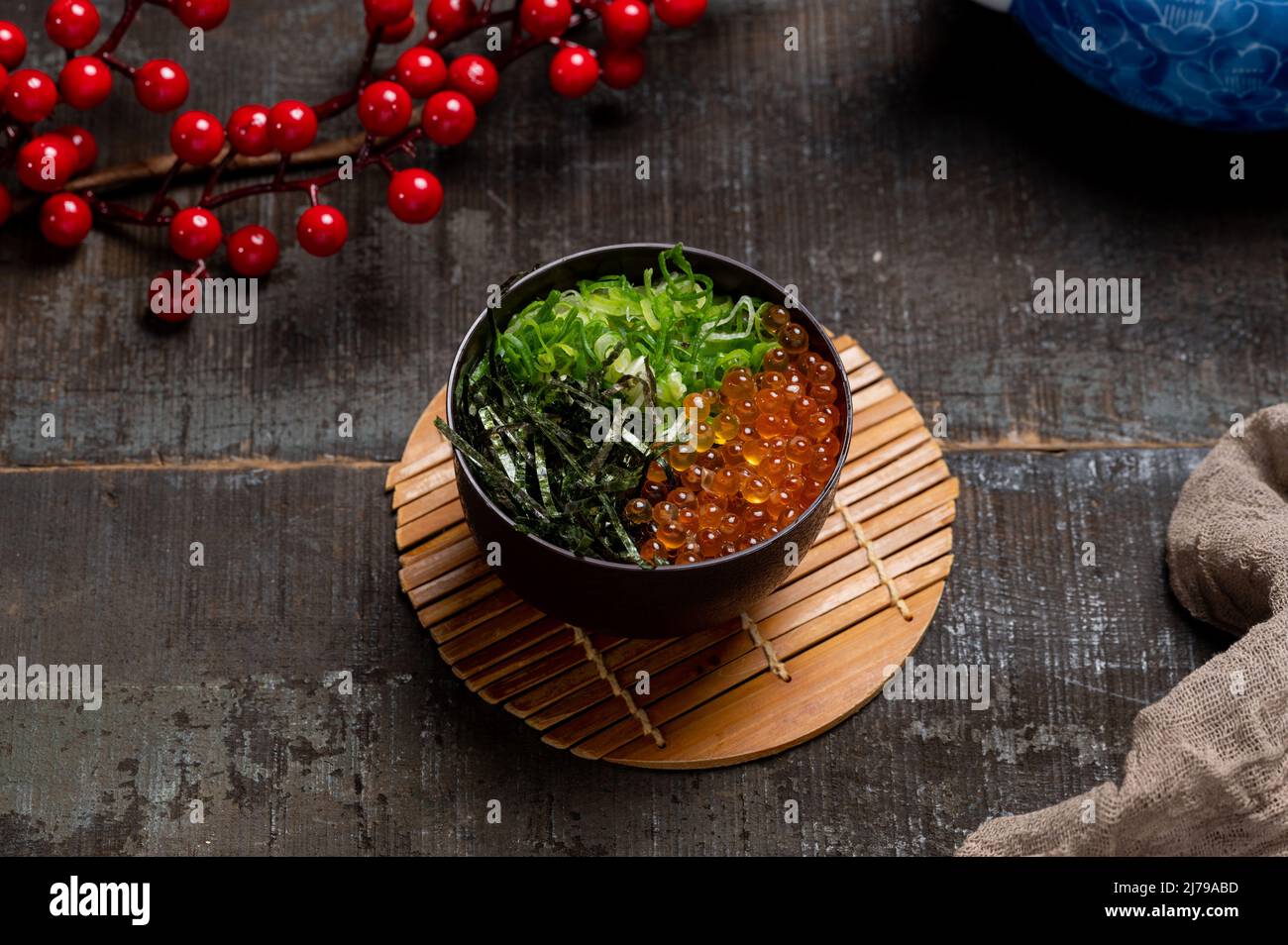 Trout Roe Chawanmushi in a bowl with chopsticks isolated on mat side ...