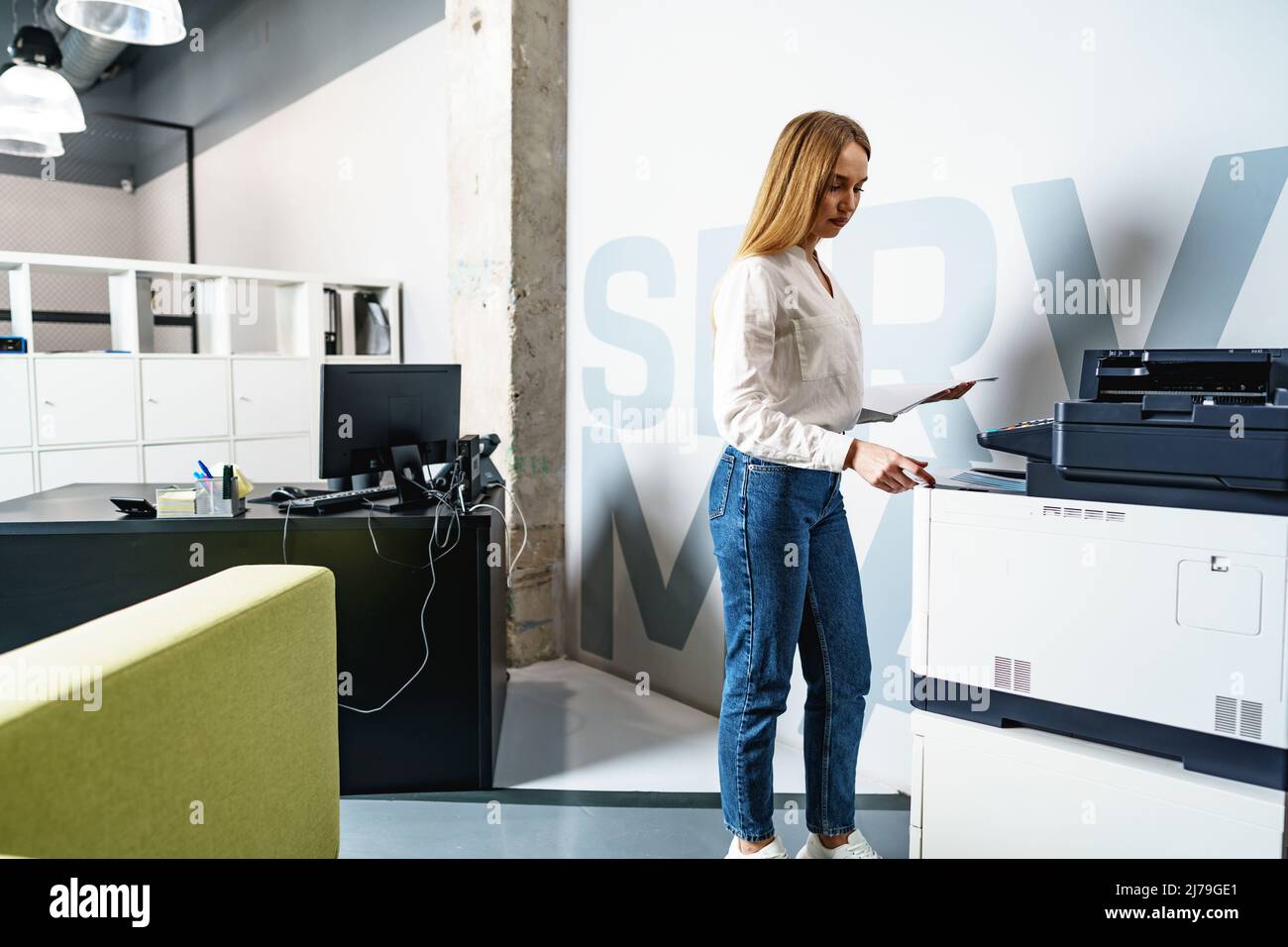 Young employee using modern printer in office Stock Photo - Alamy
