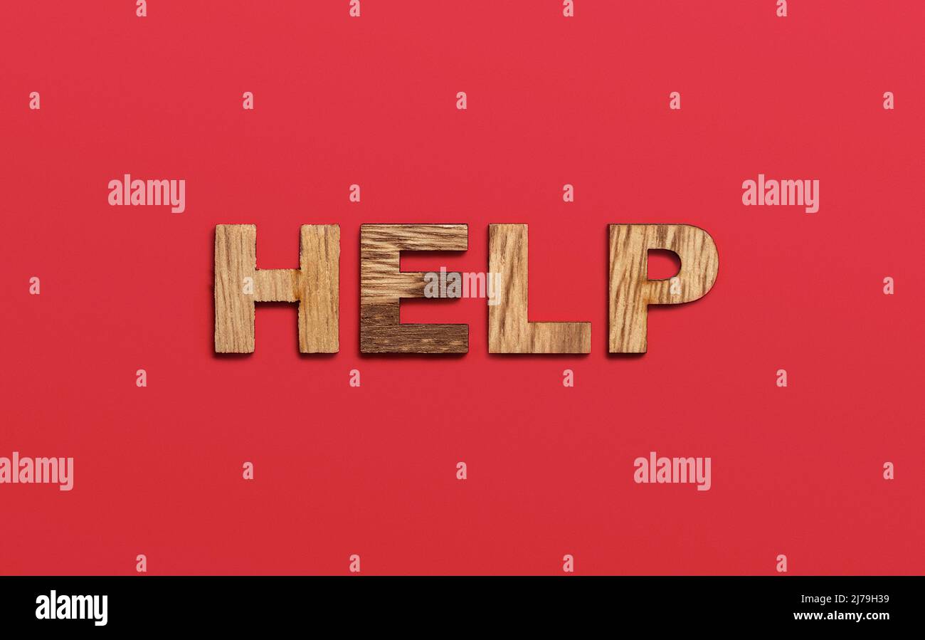 Help, word written in wooden alphabet letters on red background ...