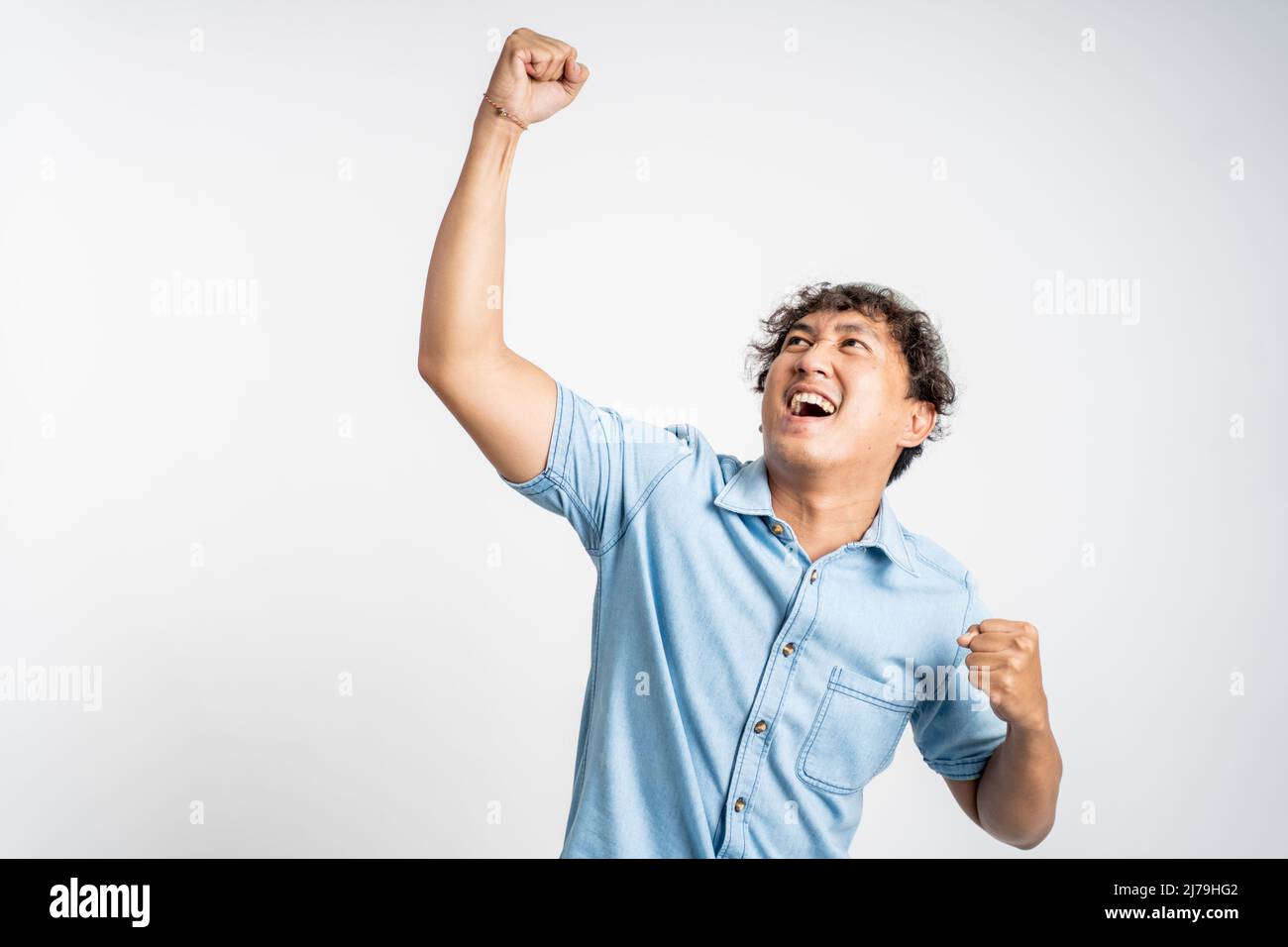 happy excited young man over isolated background Stock Photo - Alamy