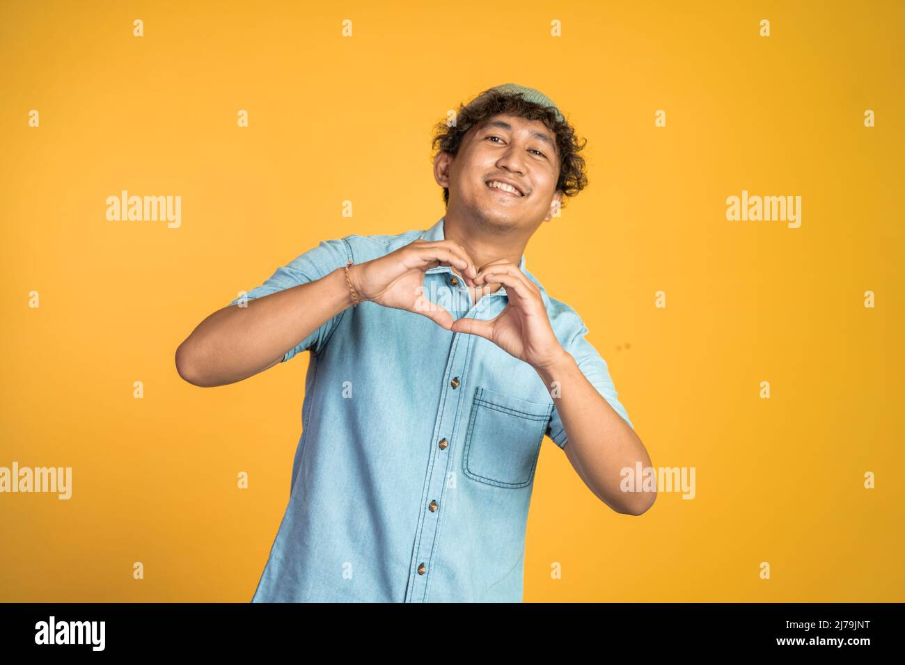 man forming a heart with finger gestures on isolated background Stock ...