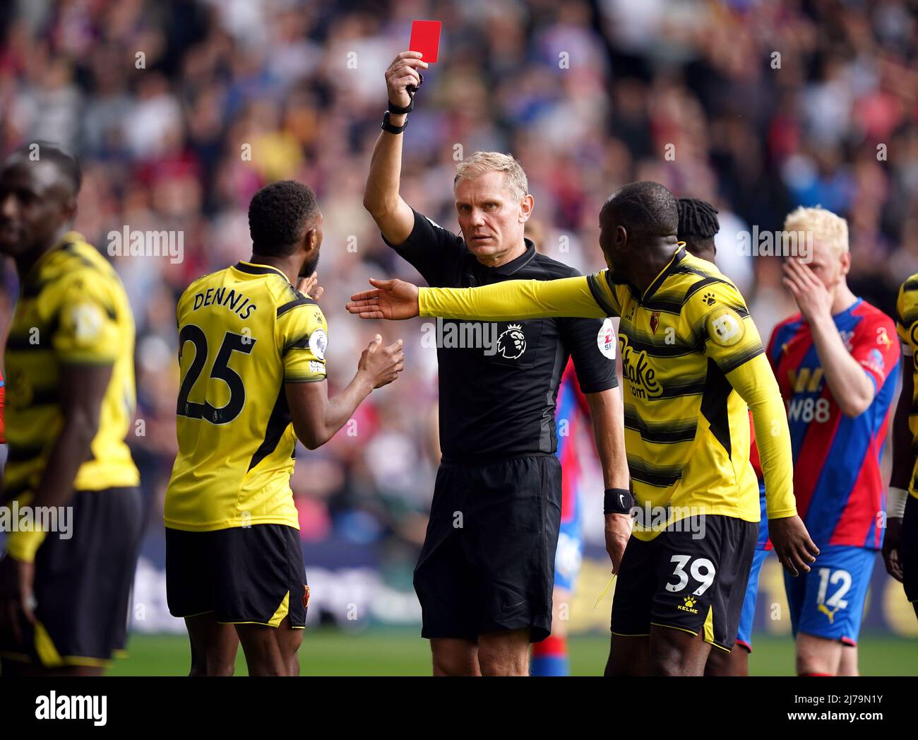 Referee Graham Scott shows a red card to Watford’s Hassane Kamara ...