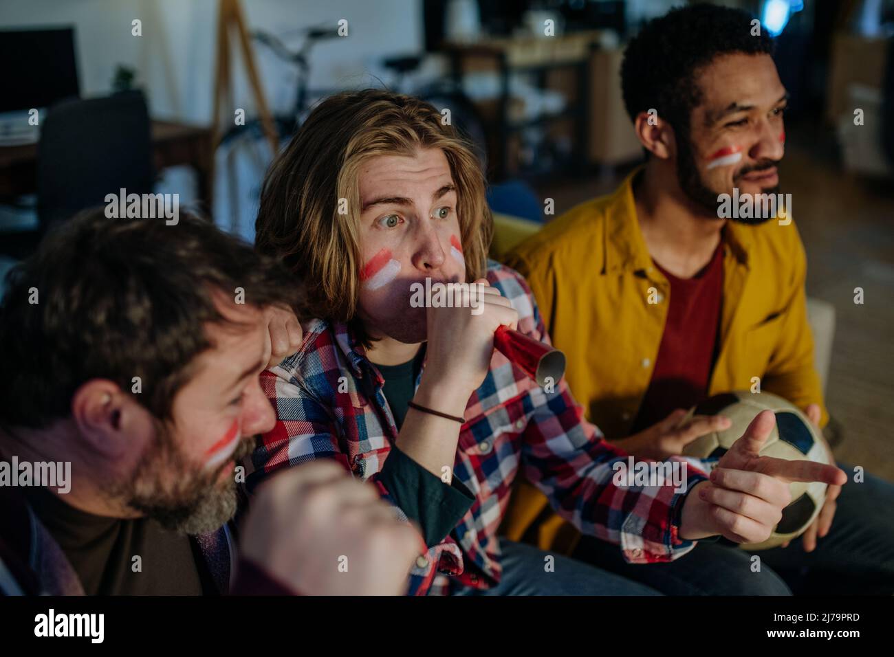 Happy Austrian football fans friends watching football at home and ...