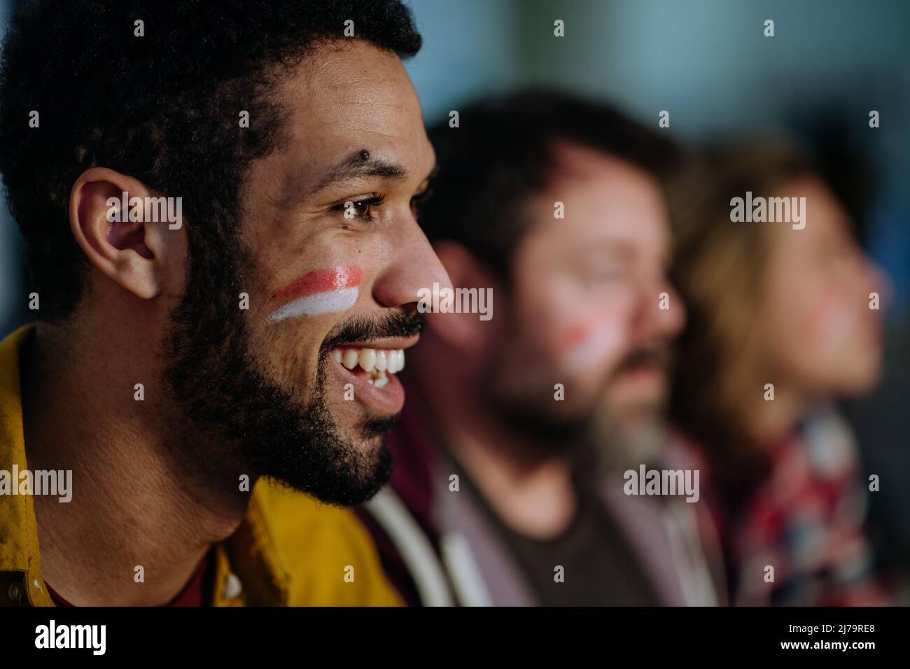 Happy Austrian football fans friends watching football at home and ...
