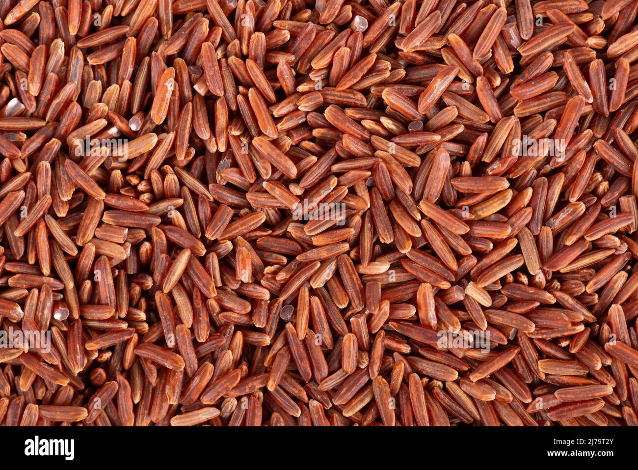 Red rice background. Whole grain raw brown rice. Top view Stock Photo ...