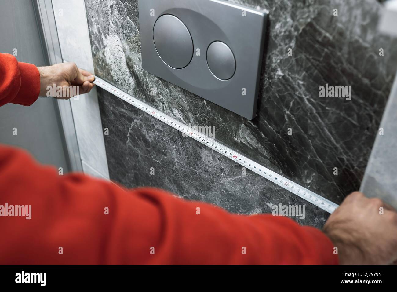 Measurement, the young man is measuring the marble walls for the new ...