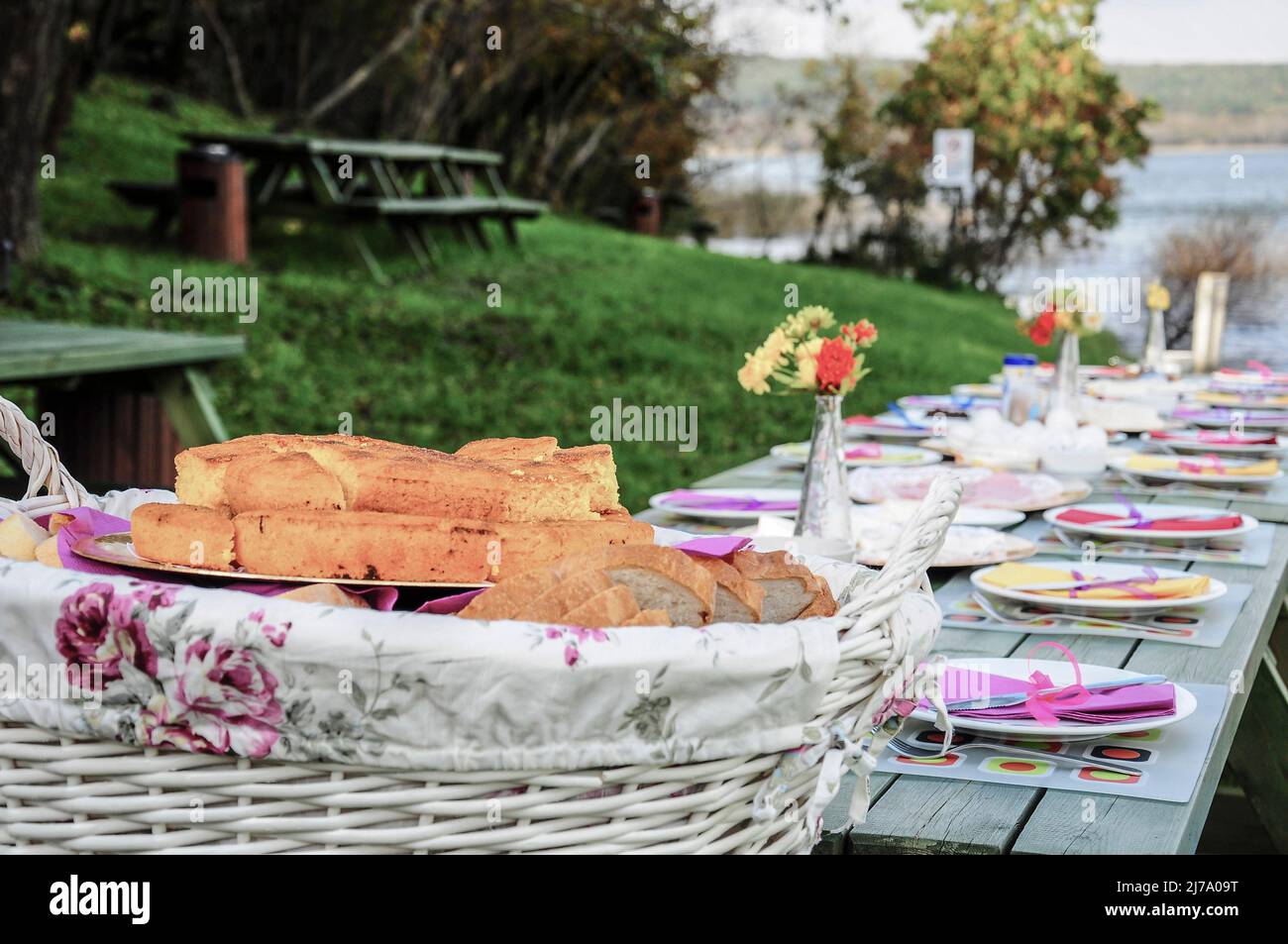 A fancy picnic table full of food by lake in summer Stock Photo - Alamy