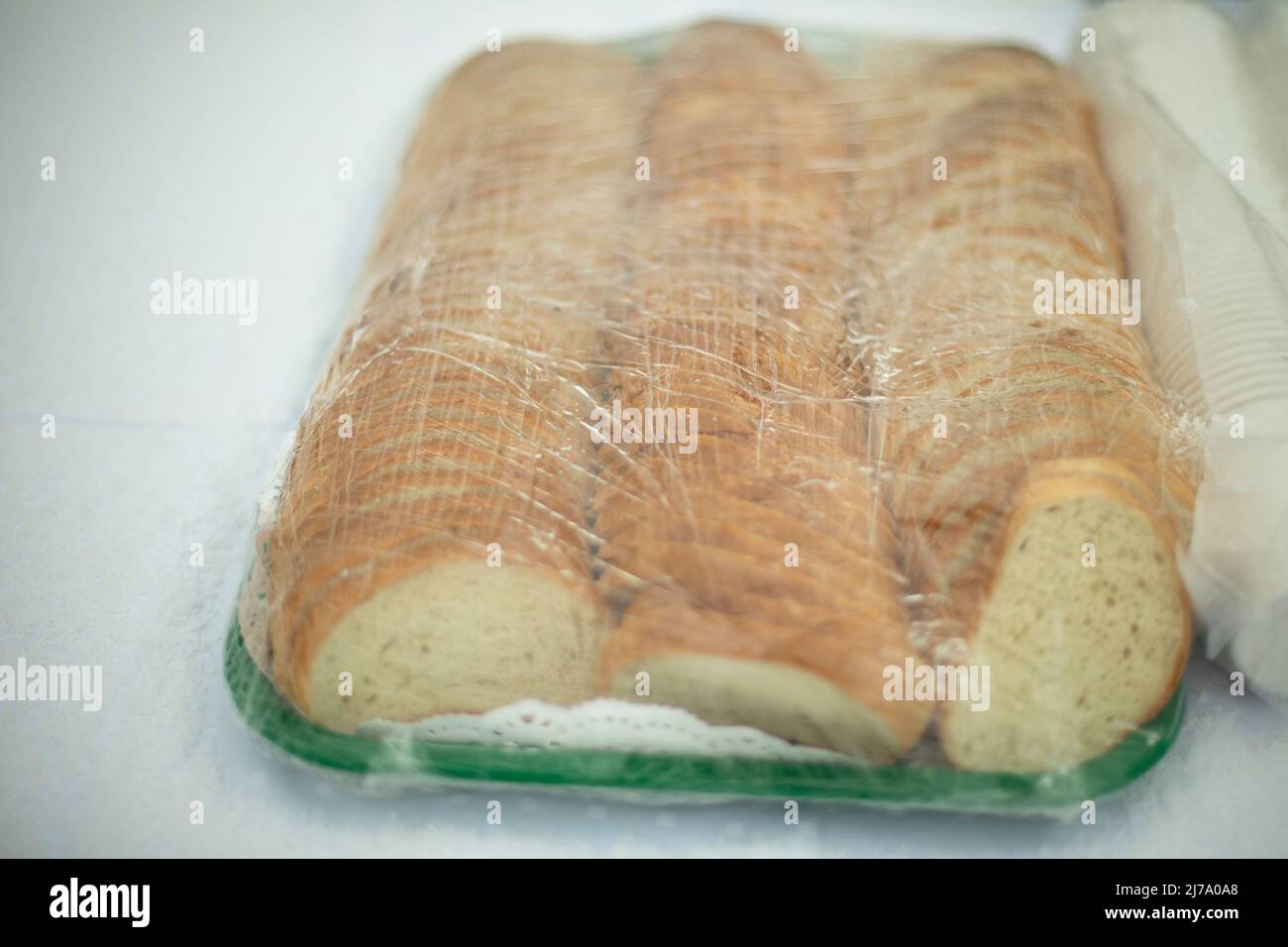Bread for refugees. Food for people. White bread outside. Flour product ...
