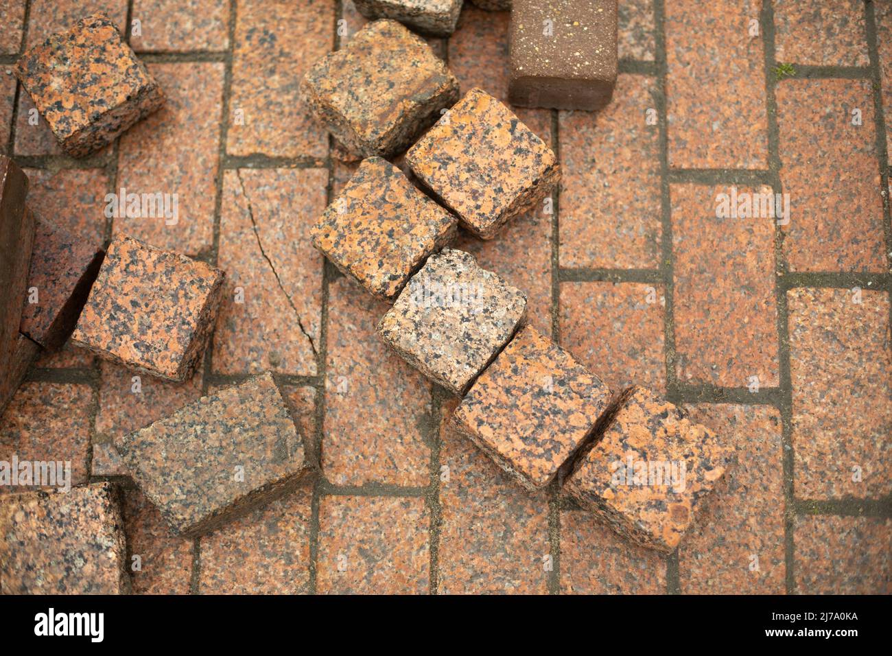 Laying tiles. Paving stones on square. Rocks on road Stock Photo - Alamy