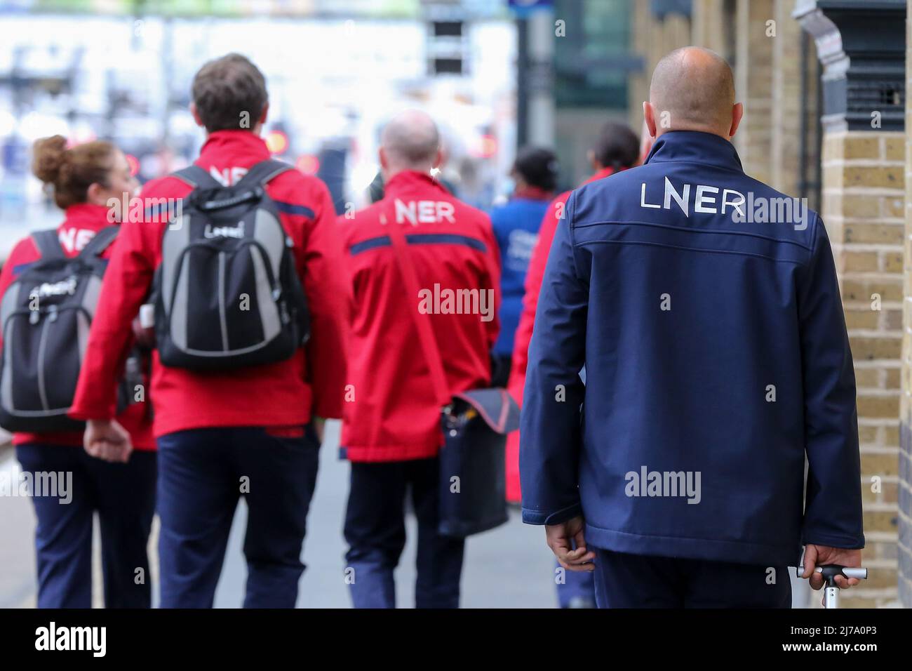 LNER staff making their way to the train at London Kings Cross station ...
