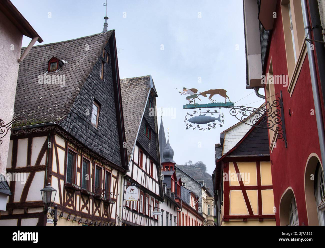 Guild sign outside a store on a street with half-timbered buildings in ...