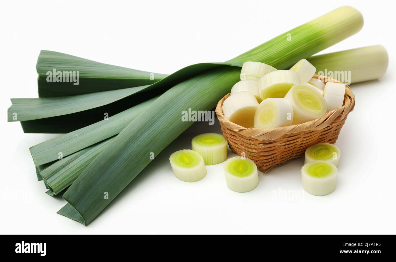 Fresh leek stems and leaves over white background Stock Photo - Alamy