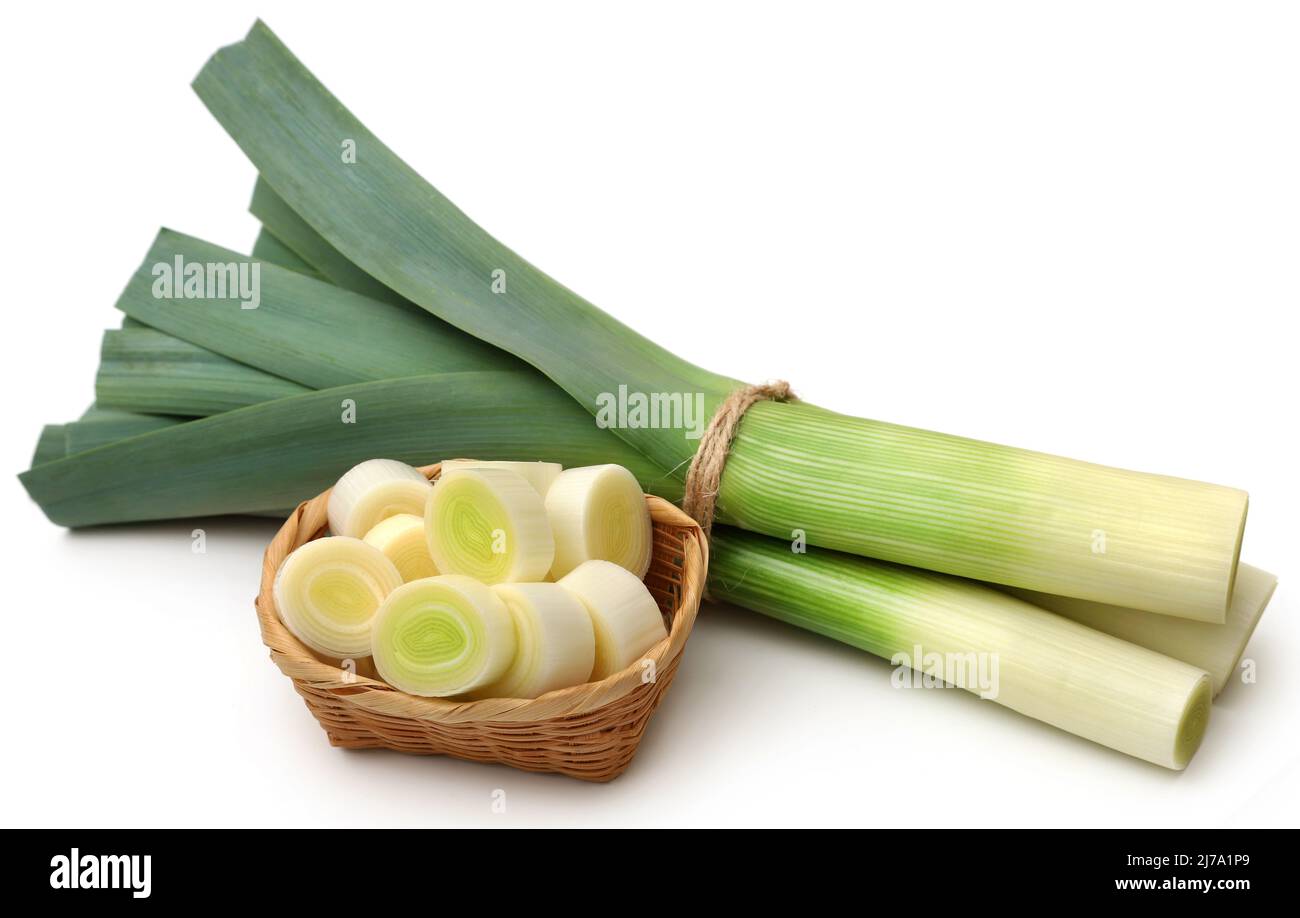 Fresh leek stems and leaves over white background Stock Photo - Alamy