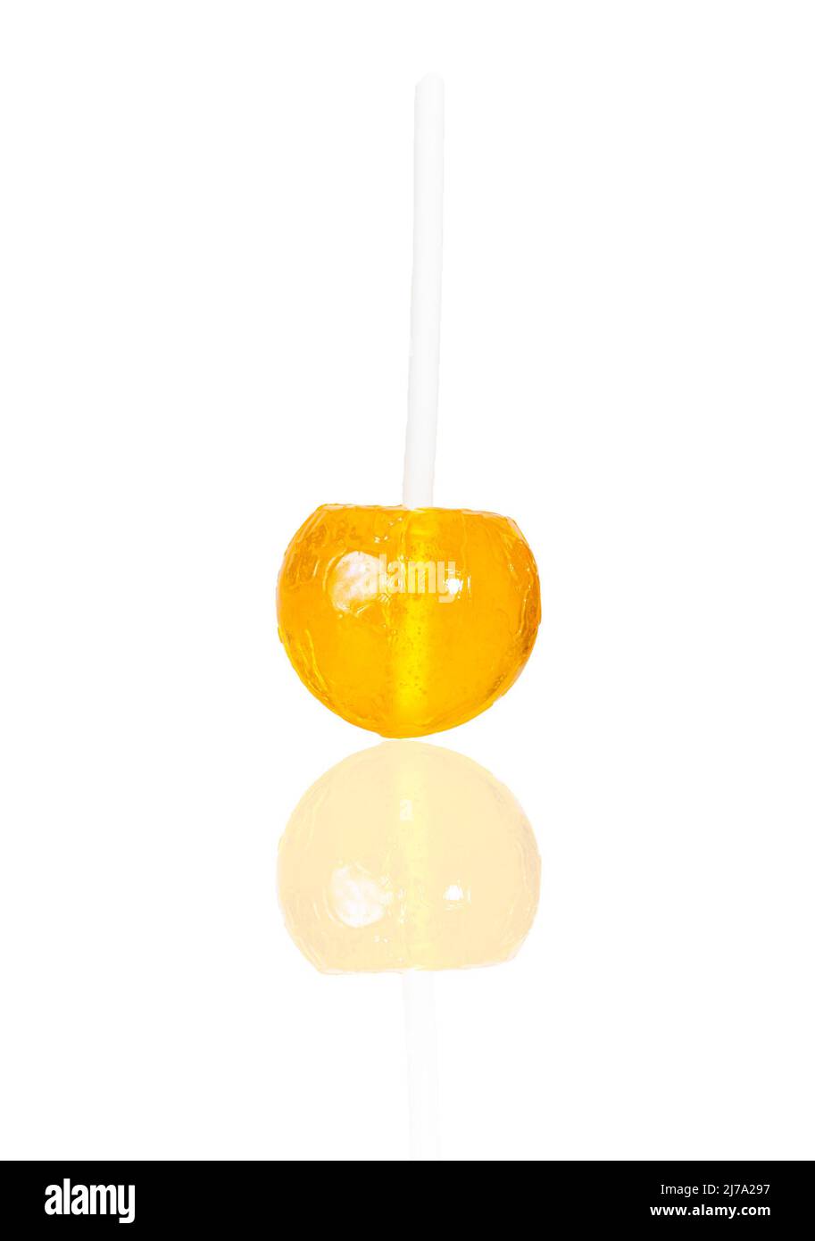 A yellow lolly pop candy on white with copy space Stock Photo - Alamy