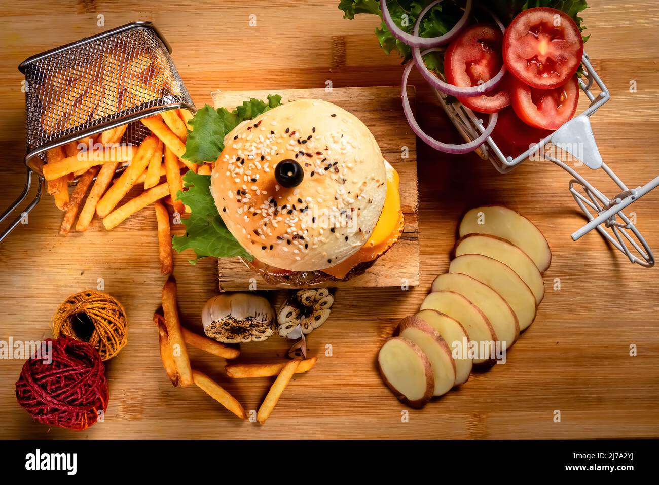 Beef Cheese burger with french fries, potato and tomato slice isolated ...