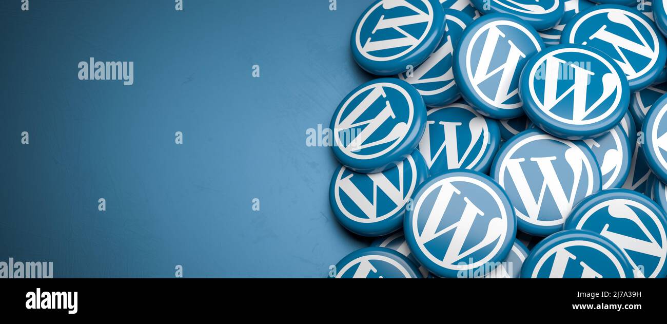 Logos of the Web Content Management System Wordpress on a heap on a table. Copy space. Web ...
