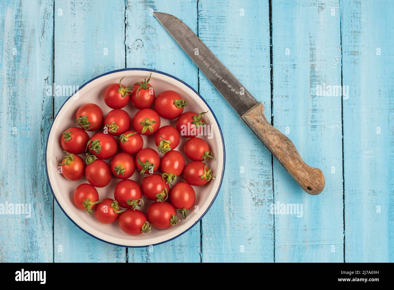 ripe cherry tomatoes on a wooden table with copy space Stock Photo - Alamy