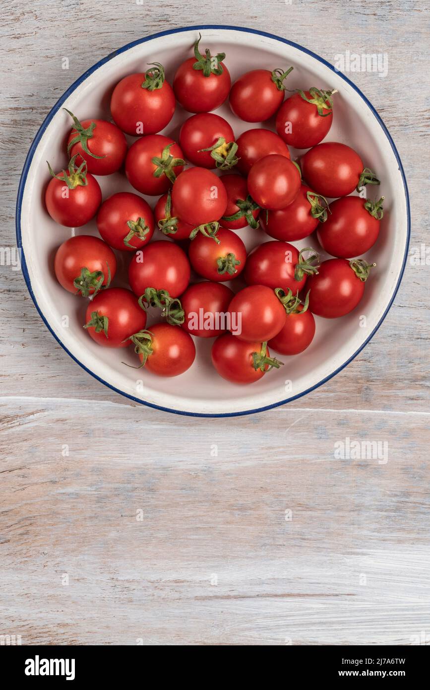 ripe cherry tomatoes on a wooden table with copy space Stock Photo - Alamy