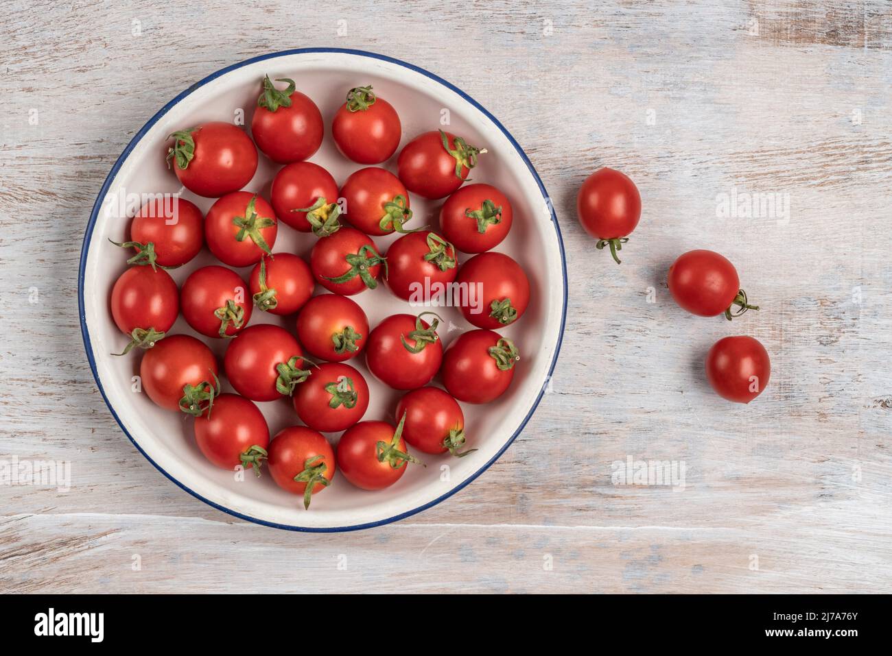 ripe cherry tomatoes on a wooden table with copy space Stock Photo - Alamy