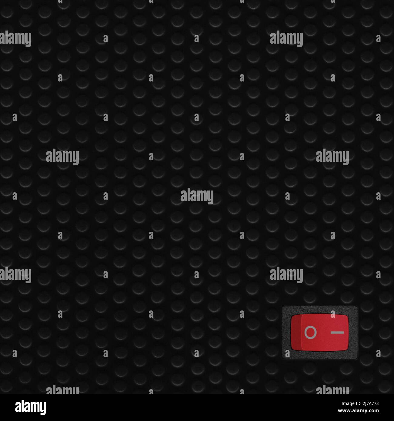 Red rectangle rocker power switch in on position, black abstract dot ...