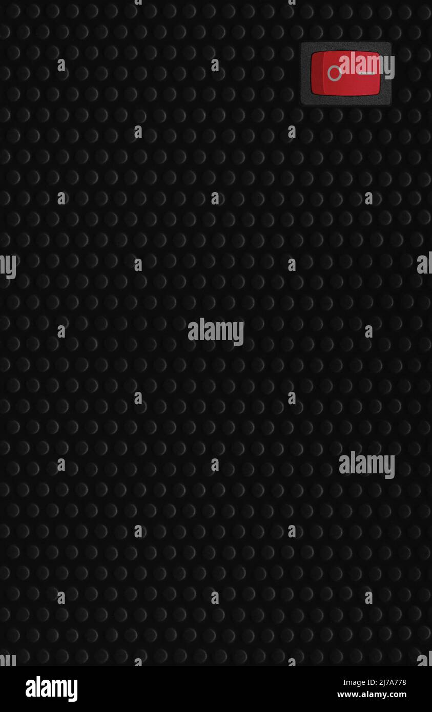 Red rectangle rocker power switch in on position, black abstract dot ...