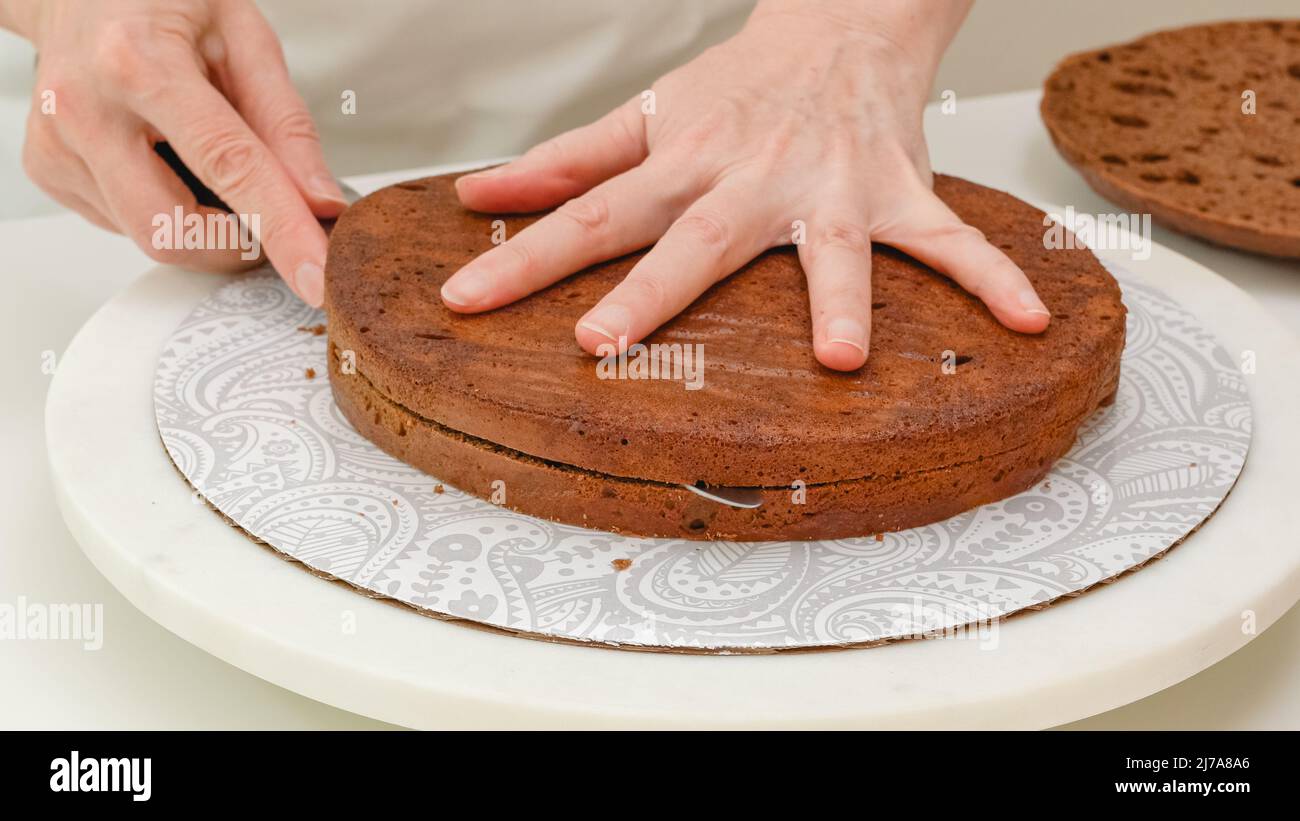 Chocolate cake step by step recipe. Woman hands slicing fresh baked ...