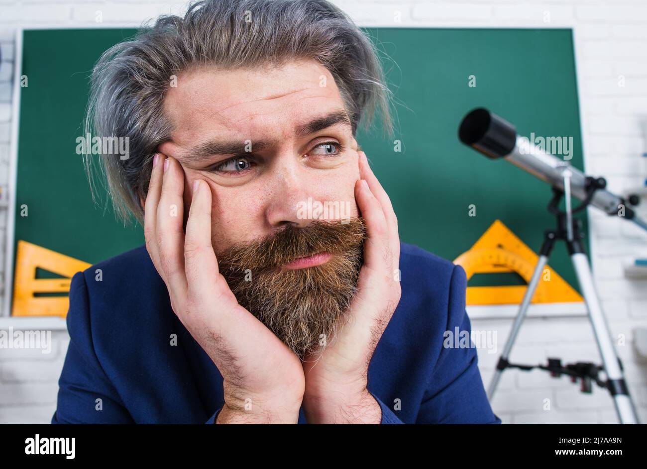 Pensive bearded teacher in classroom. Back to school. Teachers day ...