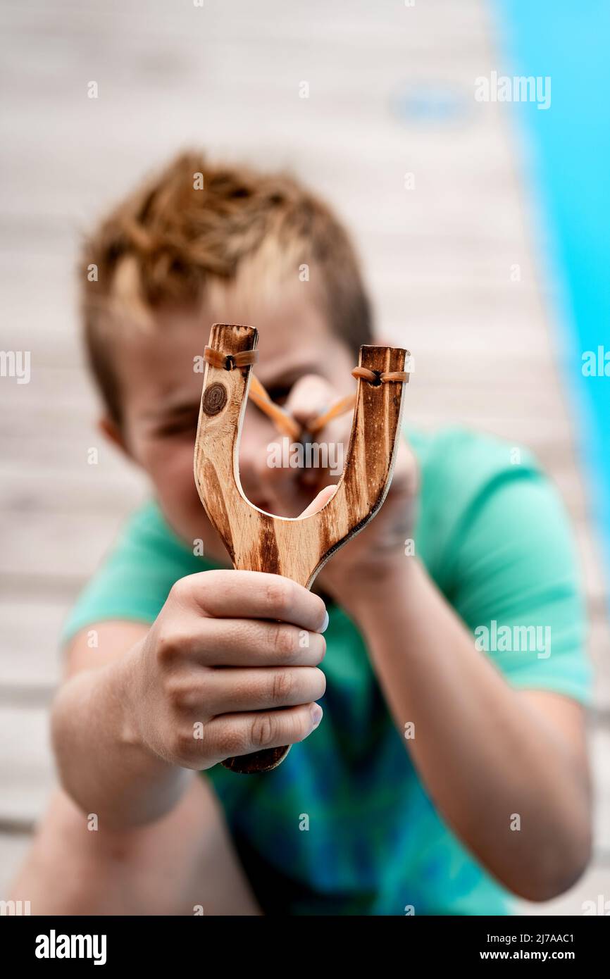 Boy aiming with slingshot hi-res stock photography and images - Alamy