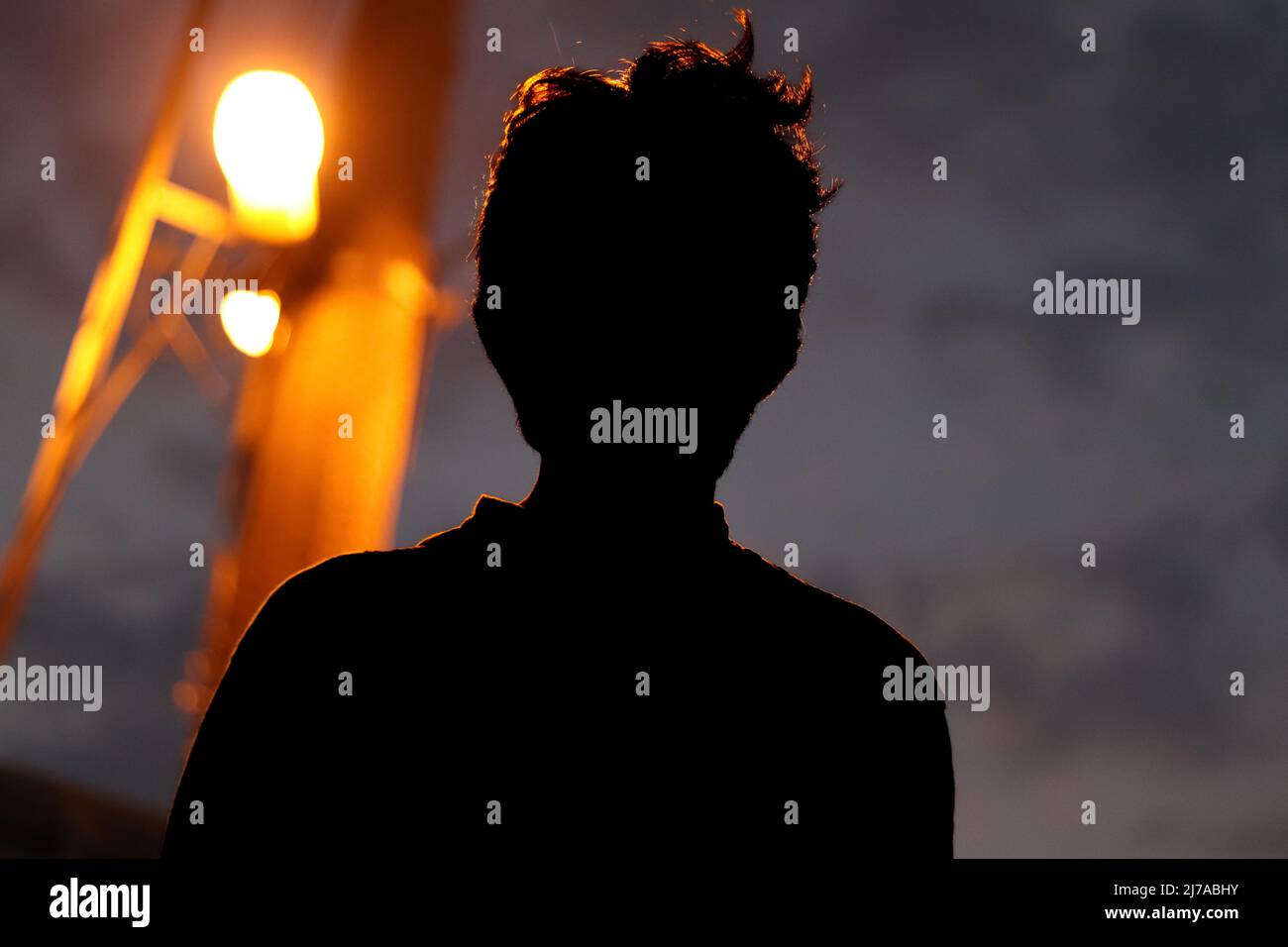 Silhouette of human subject with source light background Stock Photo ...