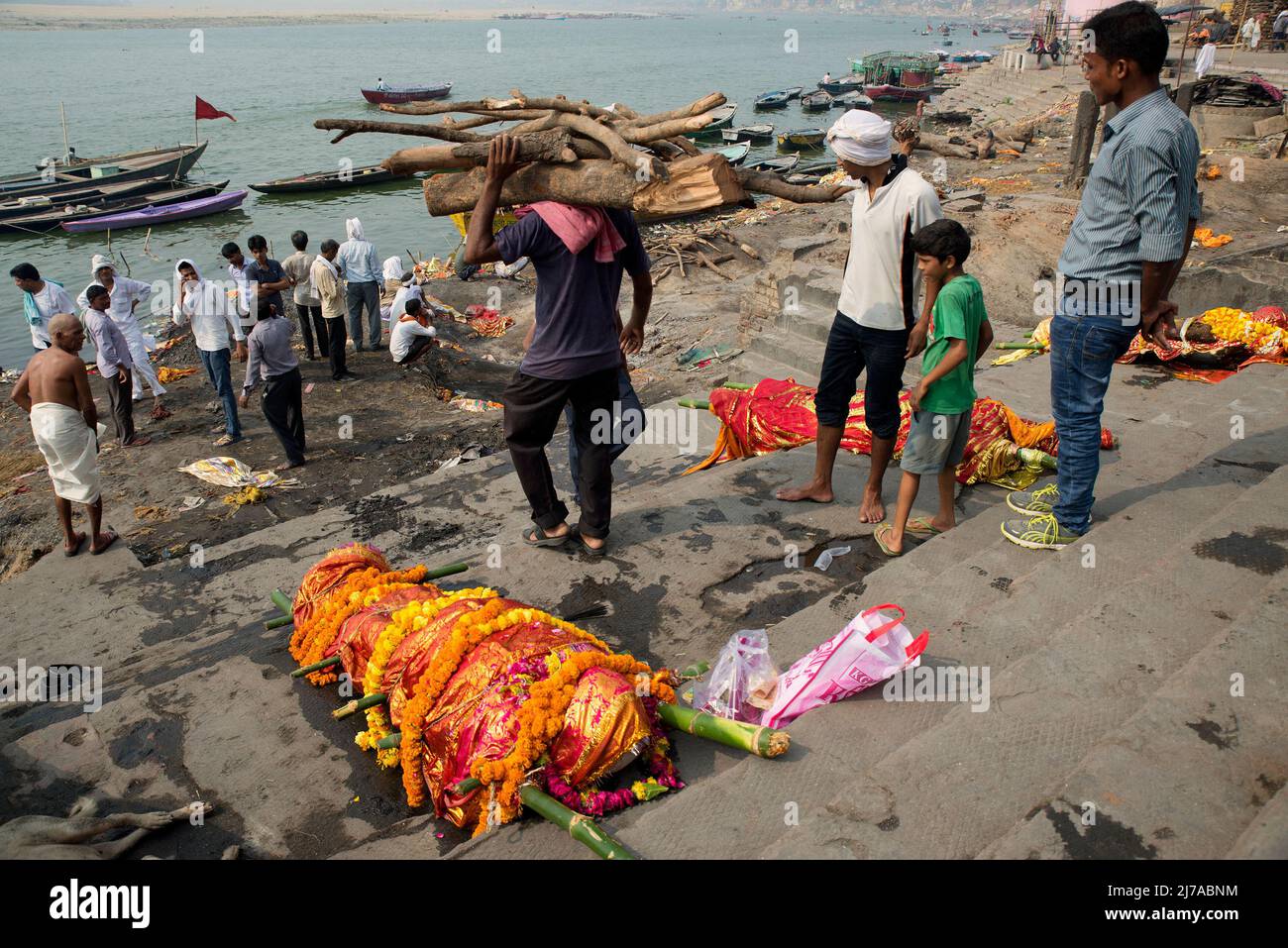 A corpse is lying to be cremated at Manikarnika ghat in Varanasi. It is ...