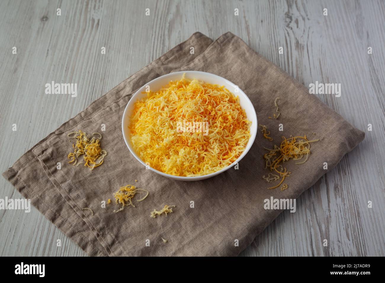 Shredded Mexican Cheese Mix in a White Bowl, side view Stock Photo - Alamy
