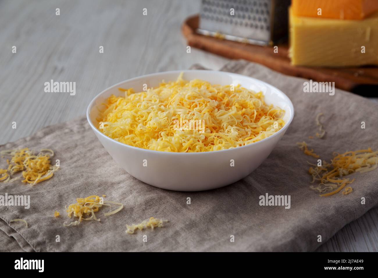 Shredded Mexican Cheese Mix in a White Bowl, side view Stock Photo - Alamy