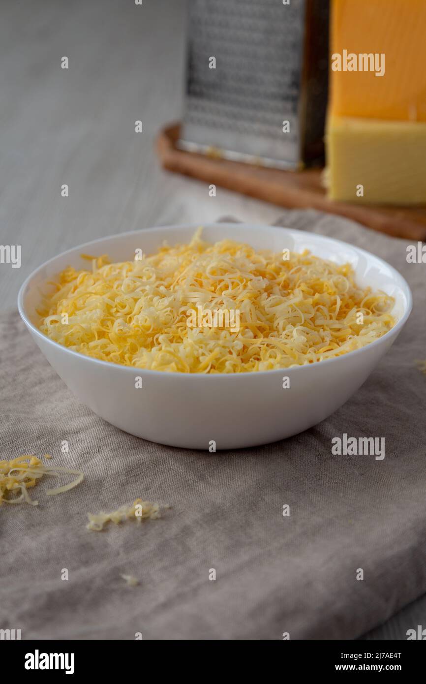 Shredded Mexican Cheese Mix in a White Bowl, side view Stock Photo - Alamy