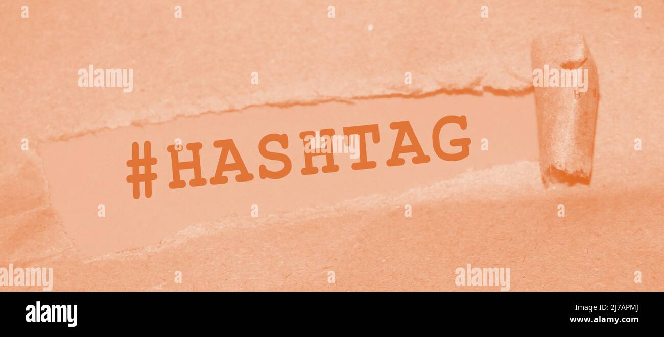 The word hashtag appearing behind torn paper Stock Photo - Alamy