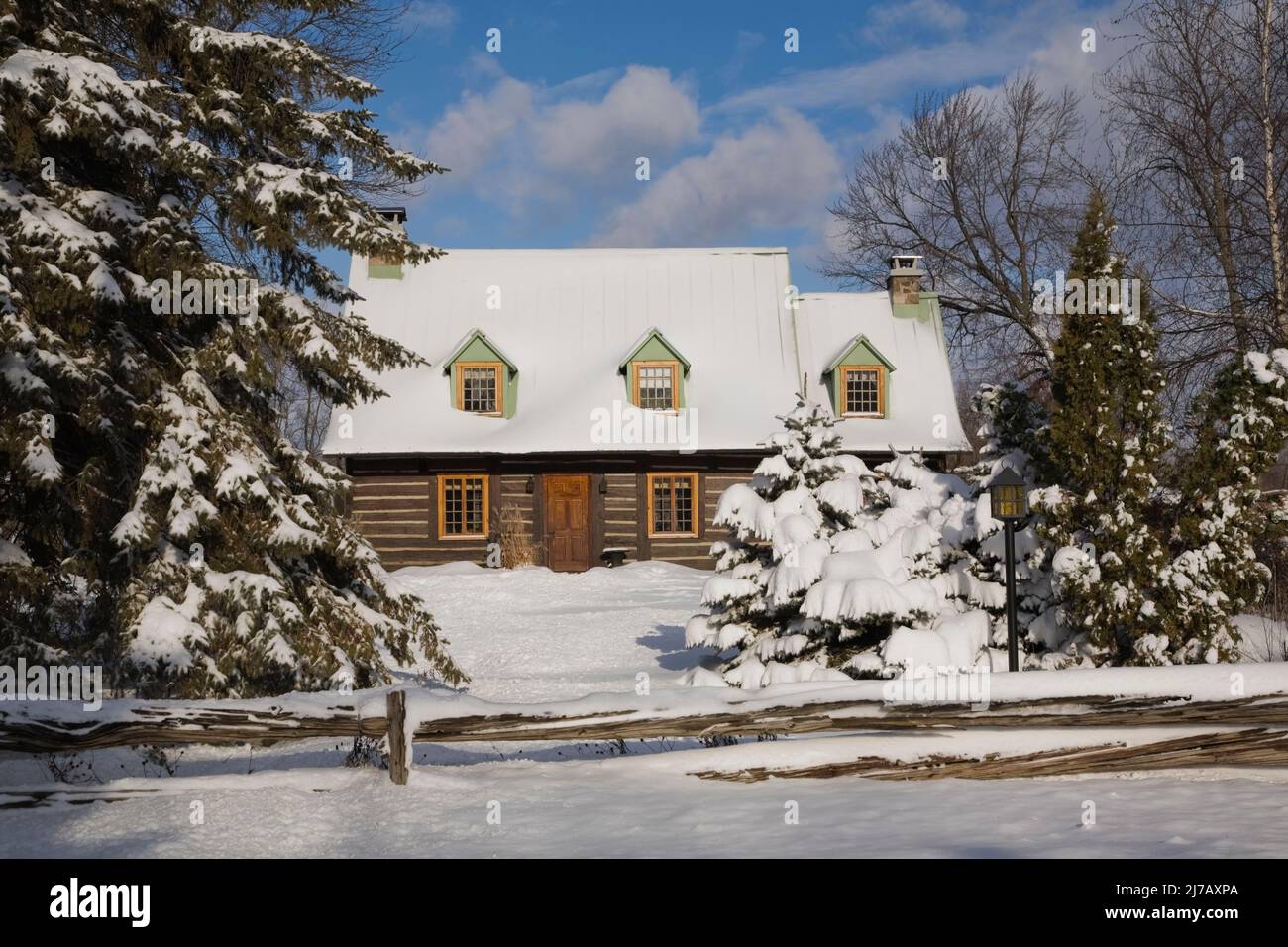 Old 1800s Canadiana style log home protected by rustic wooden perch ...