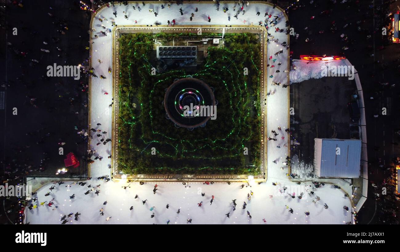 Very beautiful urban landscape with many people skating on an open-air ...