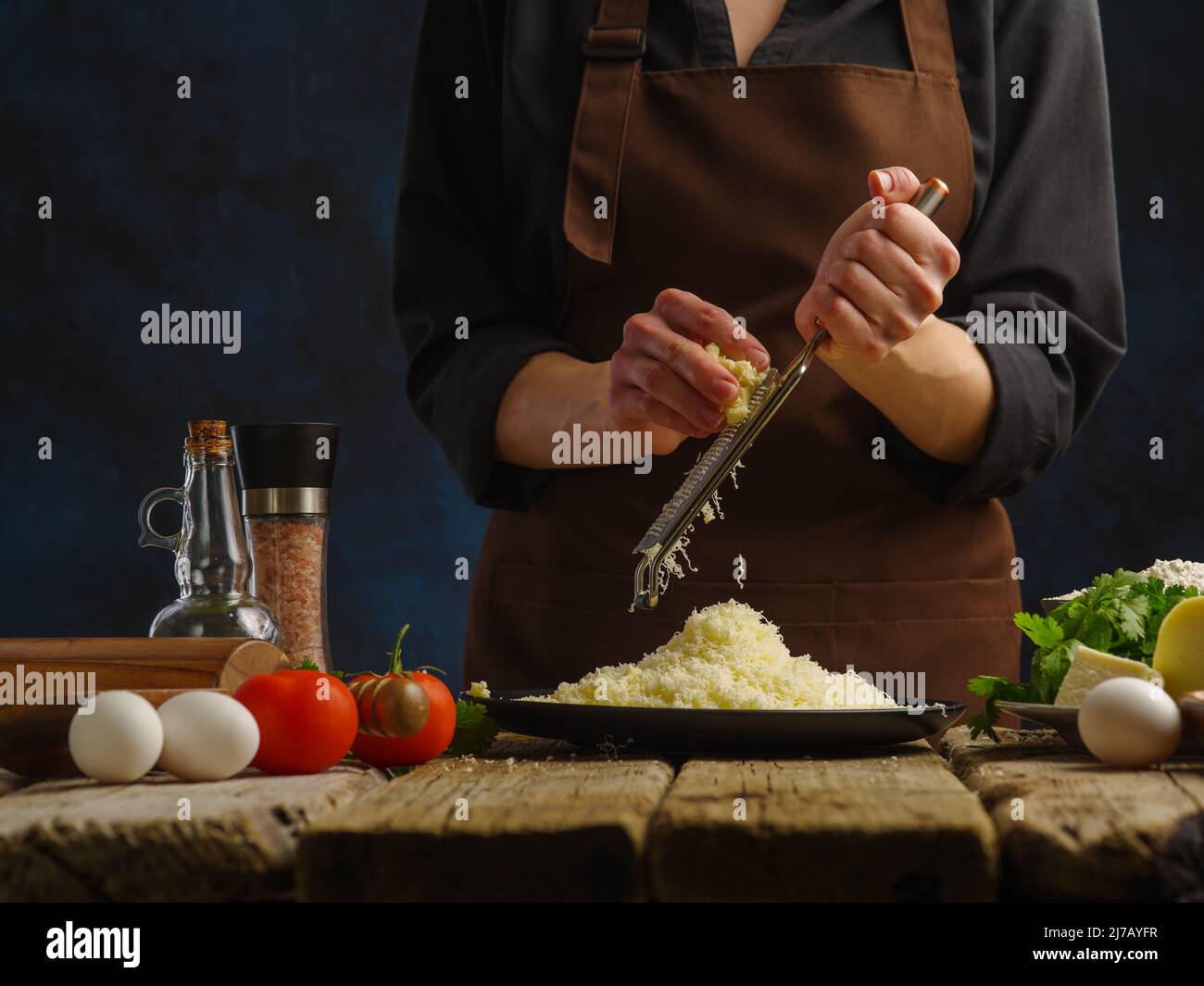 The process of preparing dishes from grated cheese, vegetables, herbs ...