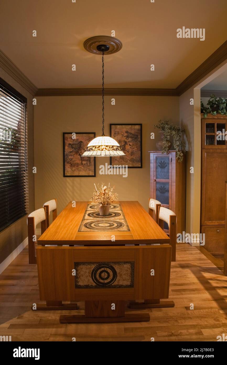 Teak wood with inlaid ceramic tiles dining table in dining area of ...